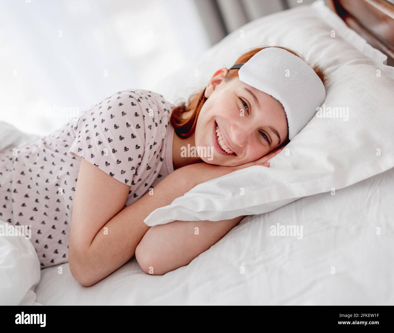 Girl smiling in the bed Stock Photo - Alamy