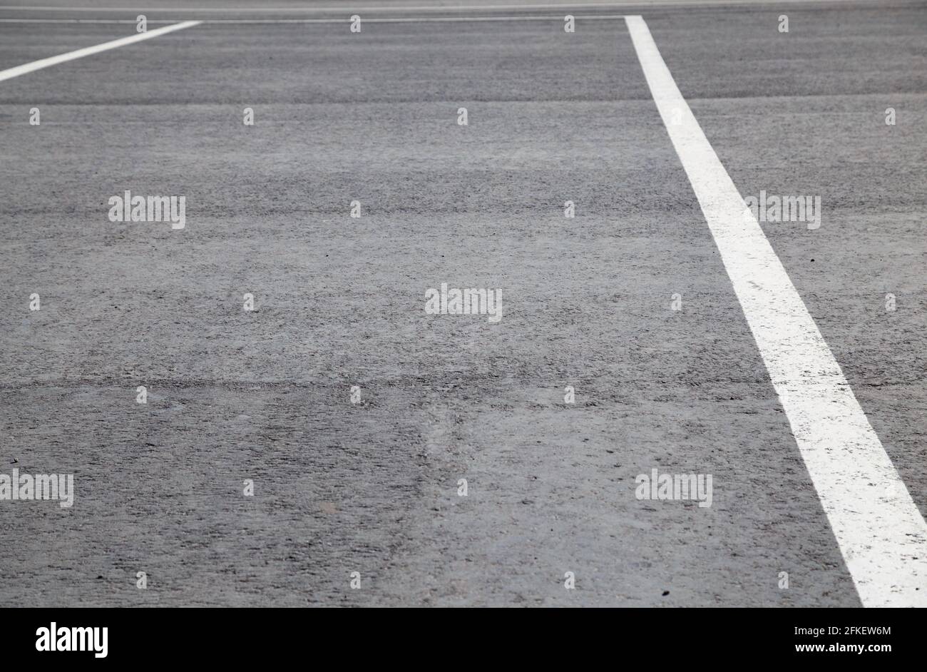 Shot of road markings on gray asphalt Stock Photo - Alamy