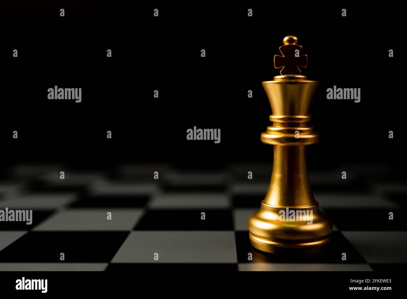 Golden Chess King standing alone on the chessboard Stock Photo - Alamy