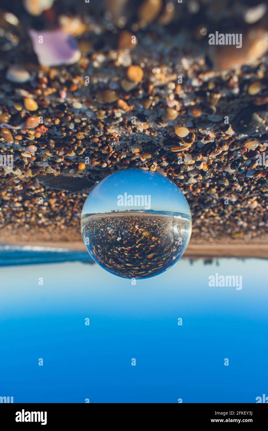Vertical shot of a crystal ball turned upside down at the beach Stock ...