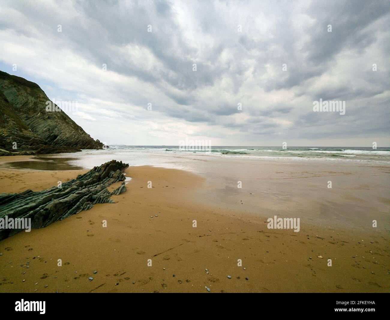 Eerie scenery of heavy clouds above a sand beach Stock Photo - Alamy