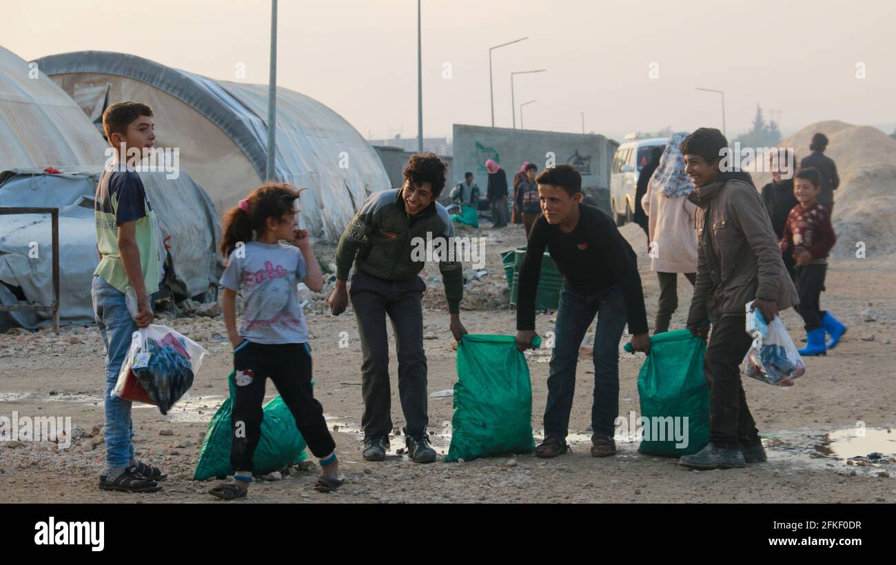 Syrian refugee children in rain in the camp near the Turkish border ...