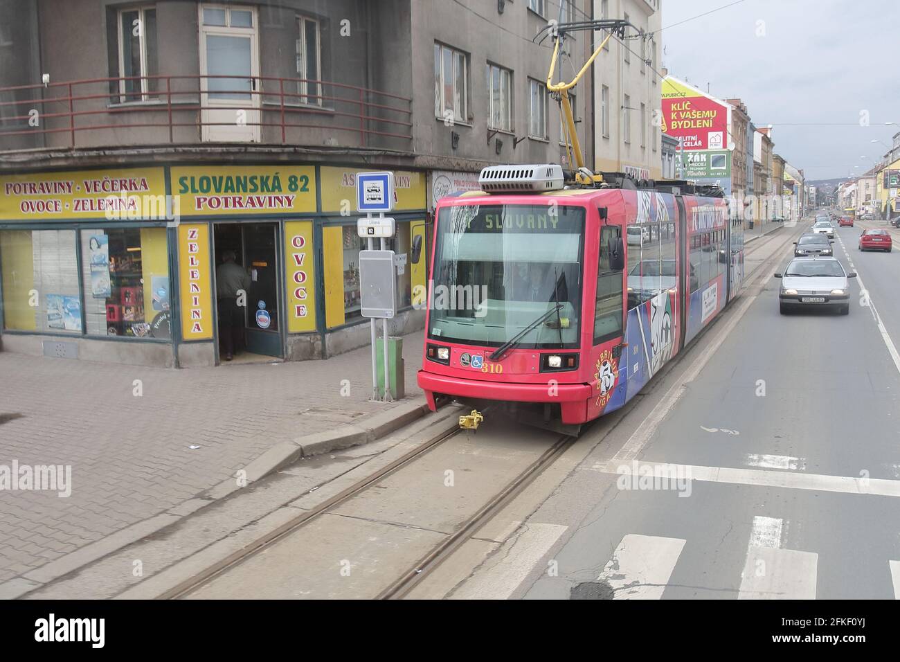 a tram is parking by a station for passengers by a road Stock Photo - Alamy