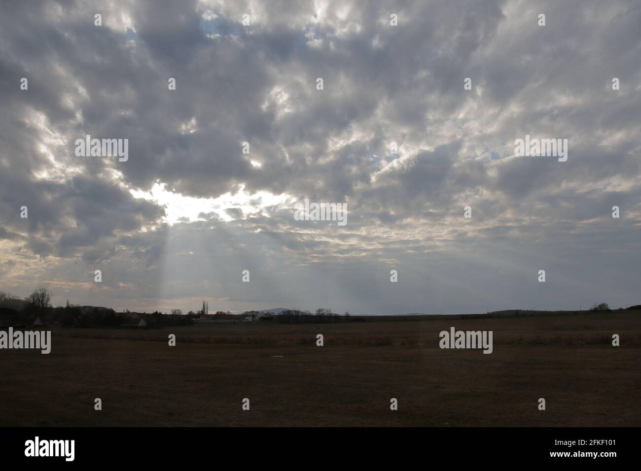 the scenery of a field under amazing crepuscular rays at dust Stock ...
