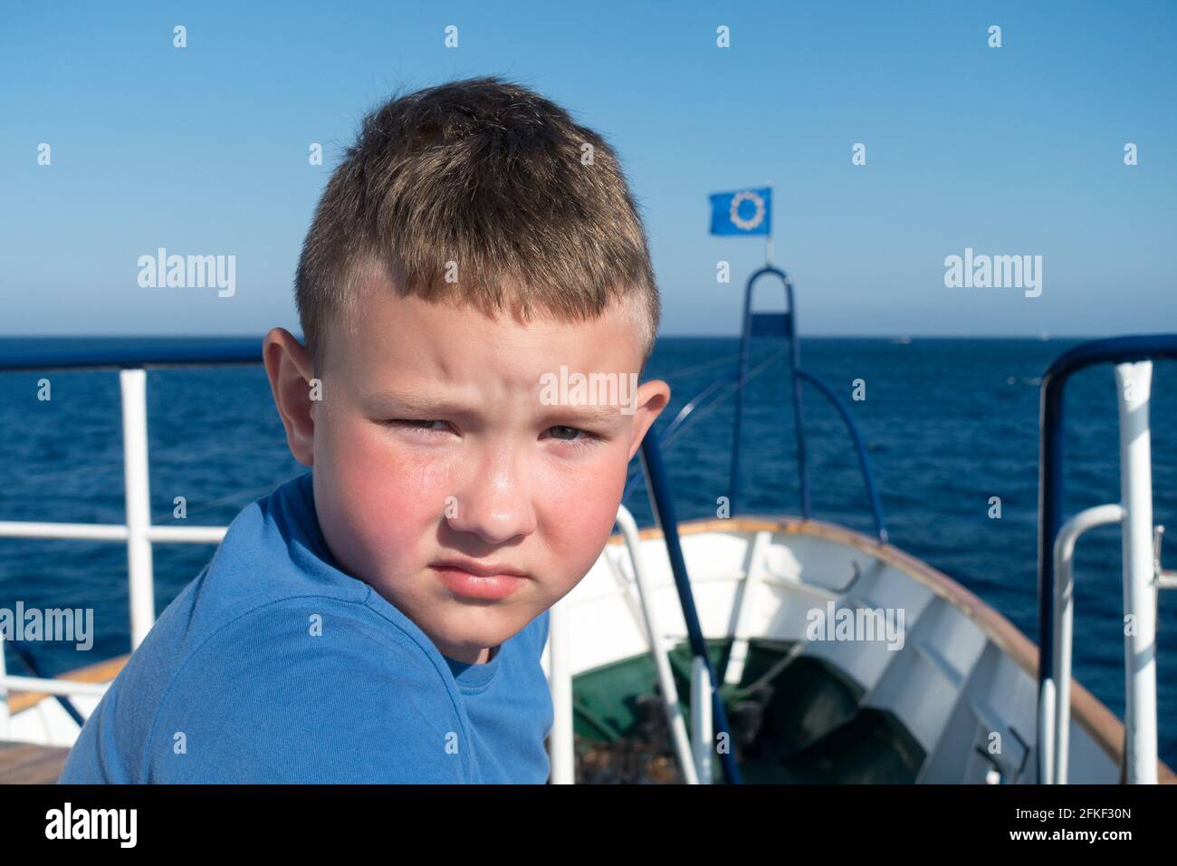 boy on a ship sets sail in the blue sea Stock Photo - Alamy
