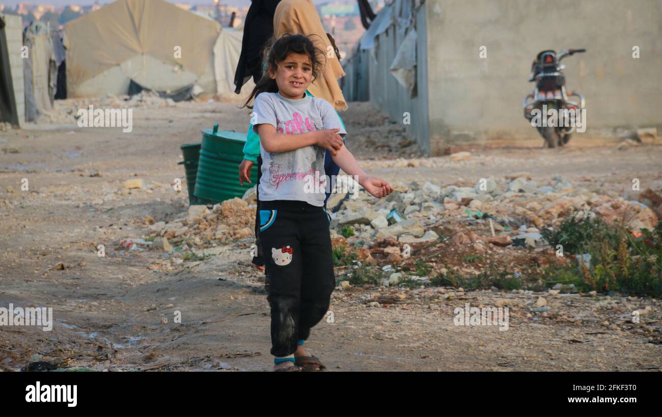 Syrian refugee children in rain in the camp near the Turkish border ...