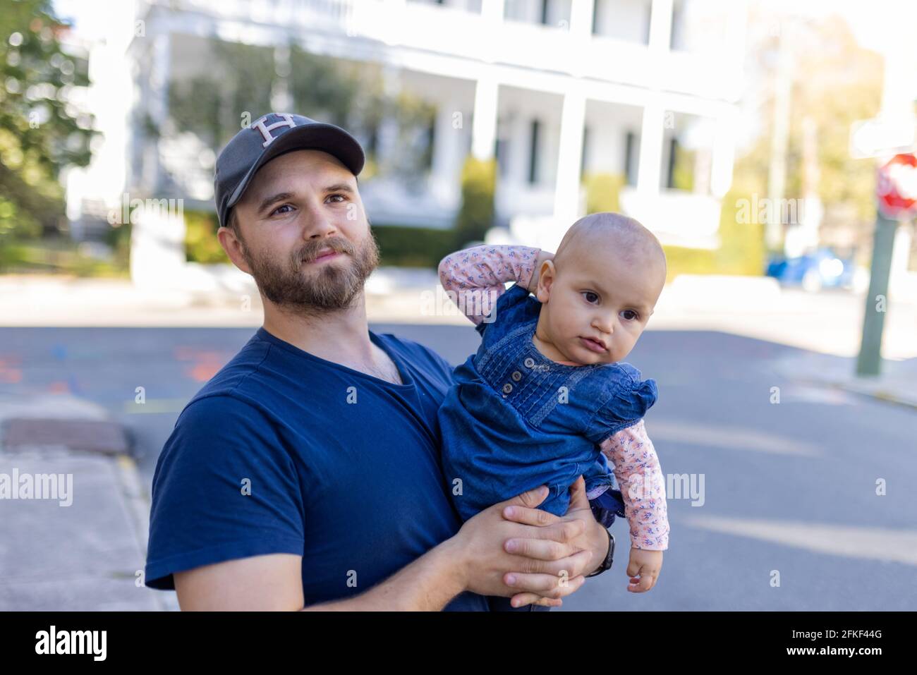 Bearded father holding his cute happy baby with blurry background Stock ...