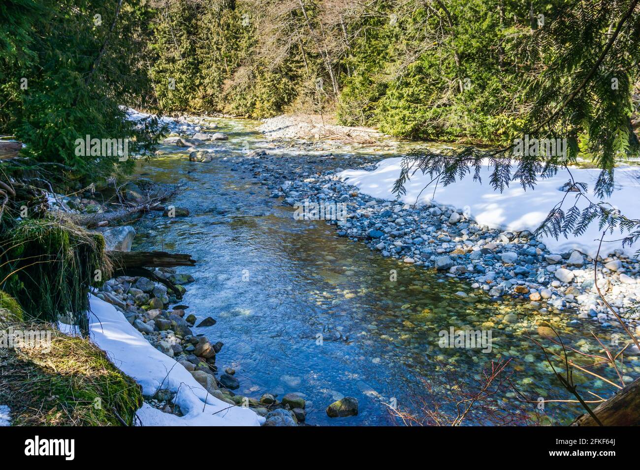 Snow lines the shore of Denny Creek in Washington State Stock Photo - Alamy