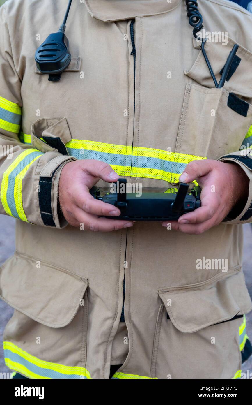 Male firefighter operating drone in search and rescue Stock Photo - Alamy