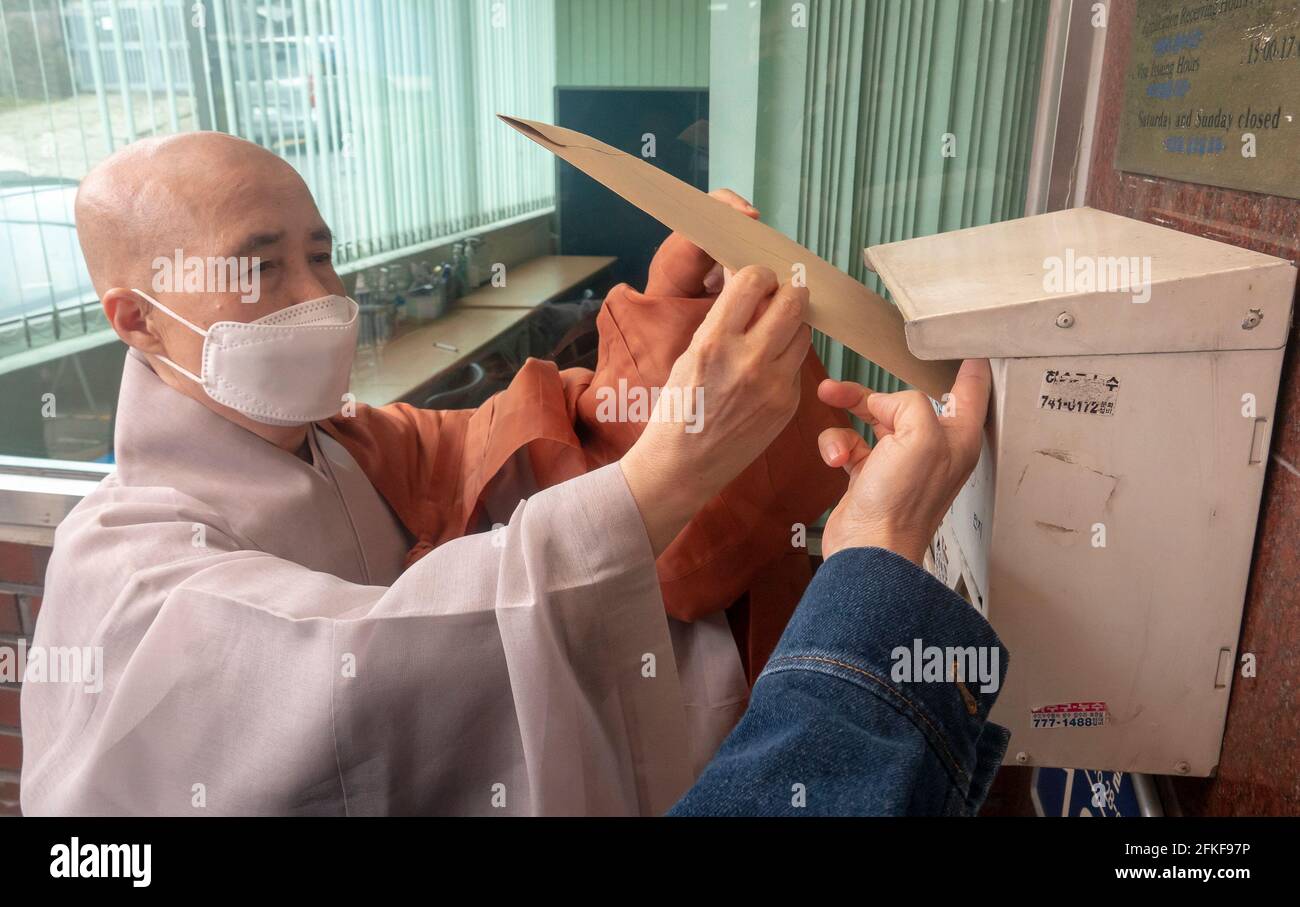 A representative of the Korean Bhiksuni Association puts a protest ...