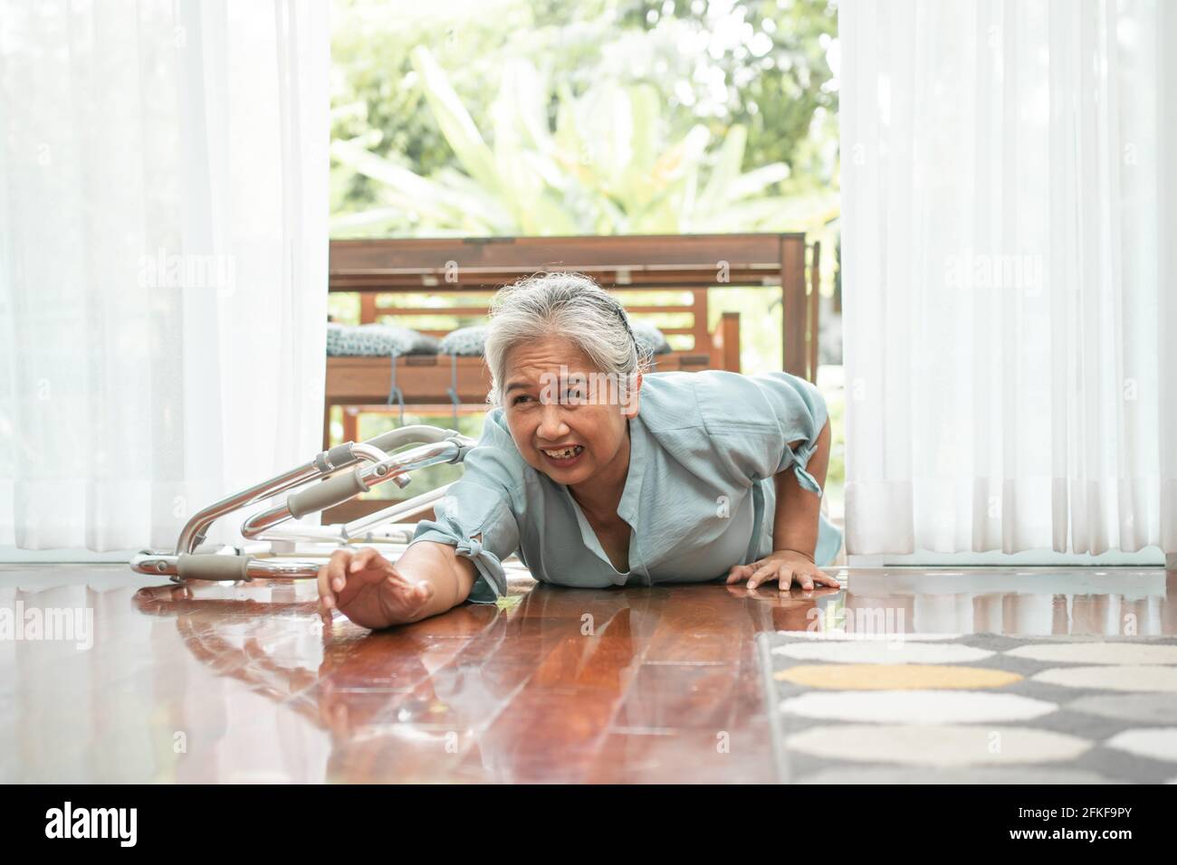Asian senior woman falling down on lying floor at home after Stumbled ...