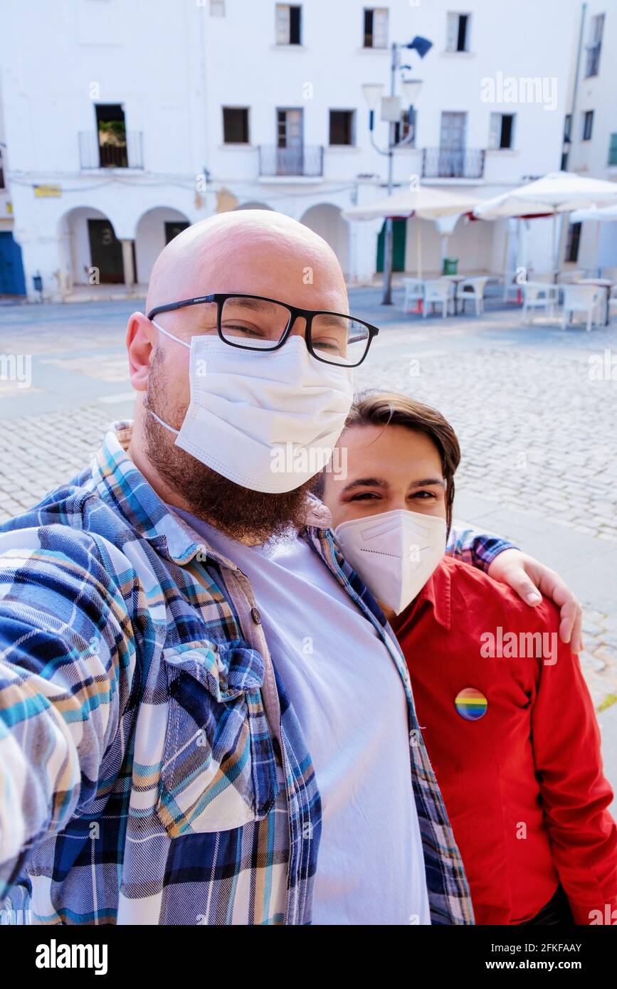 A transgender / non-binary girl with a friend, taking a selfie with ...