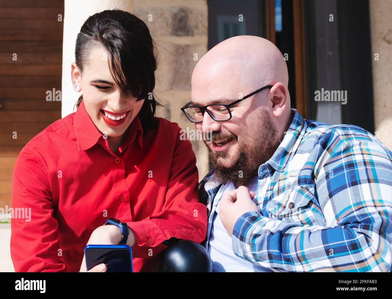 A transgender / non-binary girl with a friend, looking at the ...