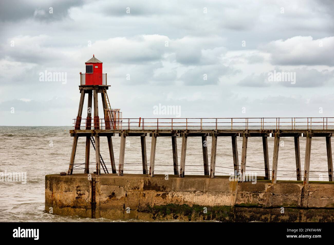 A very windy day on Whitby pier, North Yorkshire, England. Whitby is a ...