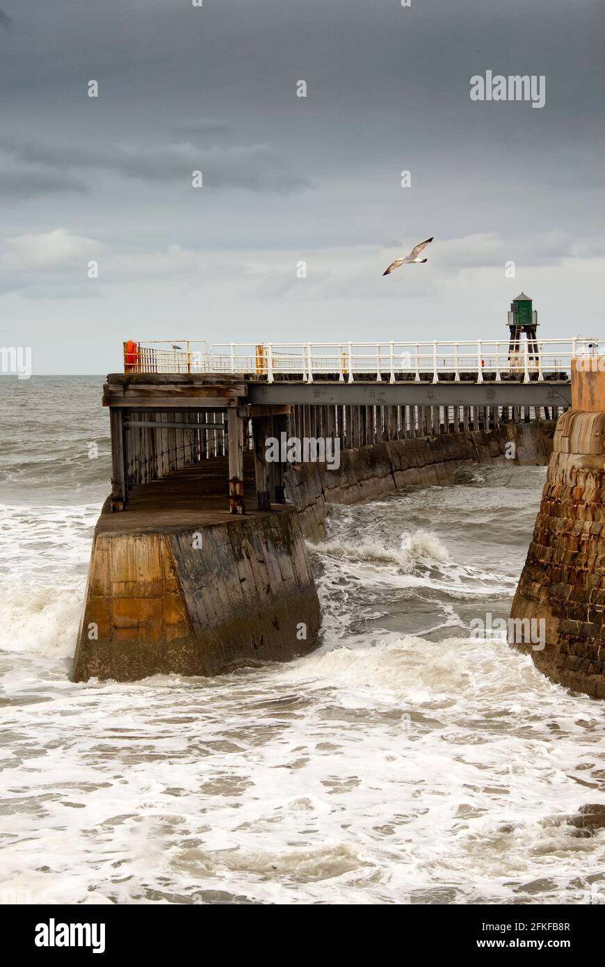 A very windy day on Whitby pier, North Yorkshire, England. Whitby is a ...