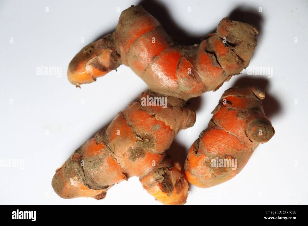 yellow colored raw turmeric closeup on white background Stock Photo - Alamy