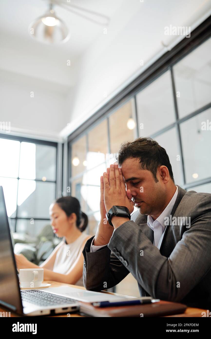 Stressed Indian entrepreneur overthinking his solution when sitting in ...