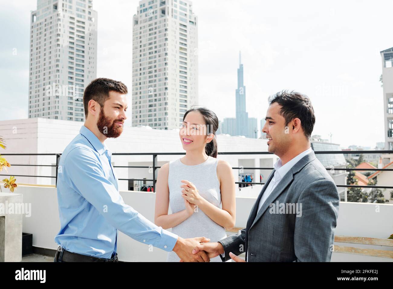 Smiling project manager and investor shaking hands after meeting on ...