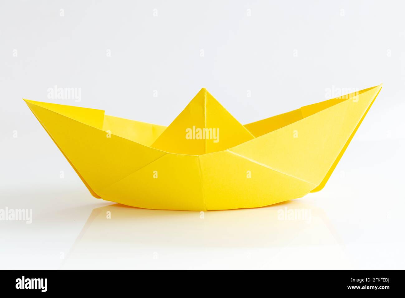 Yellow Paper boat isolated on white background Stock Photo - Alamy