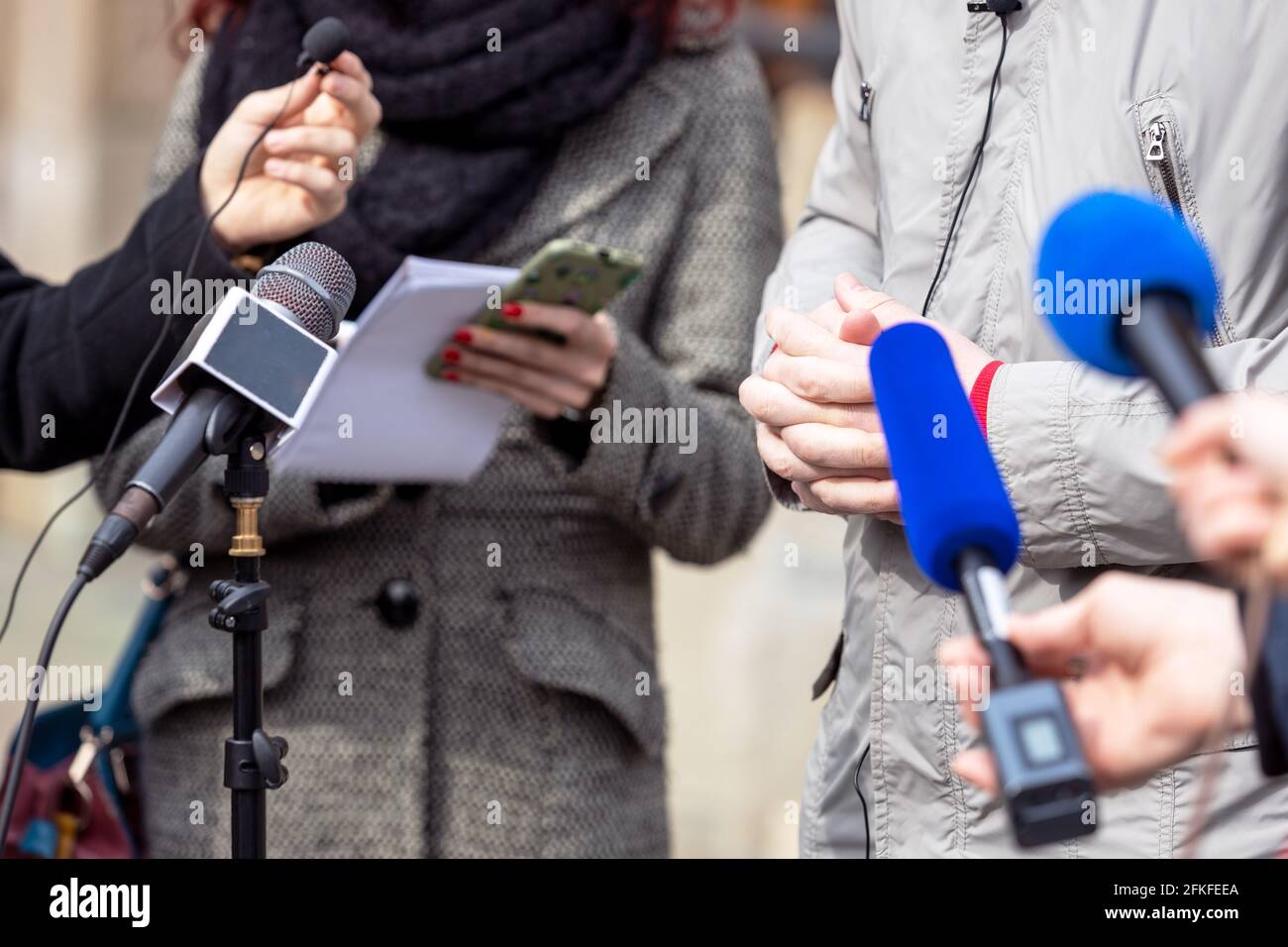 Female reporter or TV journalist at press conference, holding ...