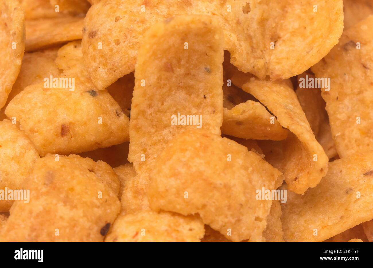 A Background of Unhealthy Oily Yellow Corn Chips Stock Photo - Alamy