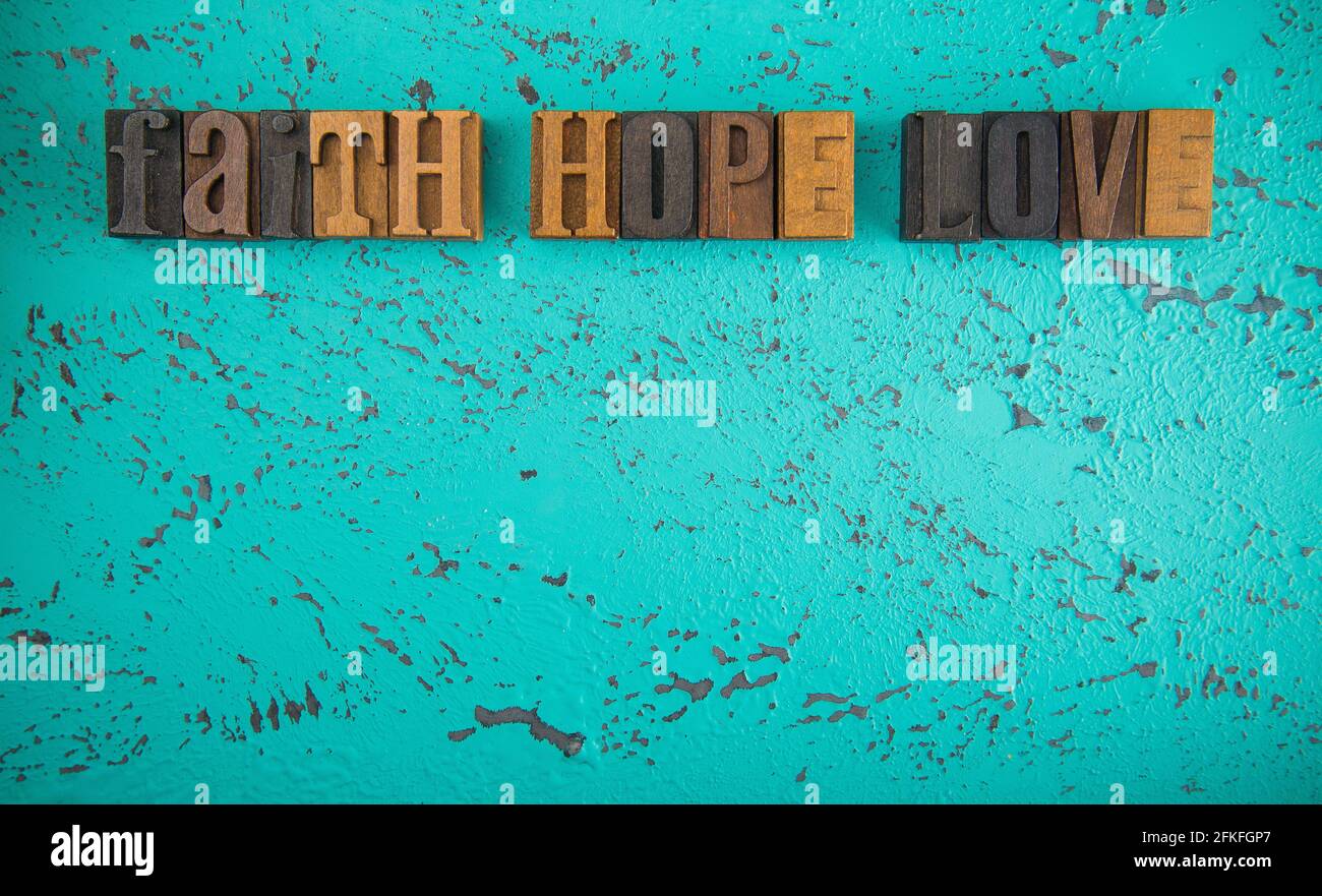 Faith Hope and Love Spelled in Wooden Type Set Block Letters on a ...