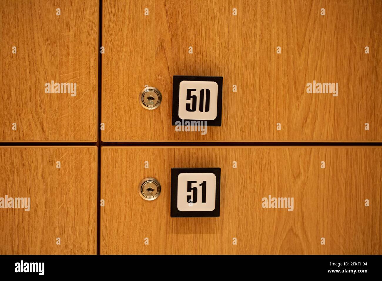 Modern wood cabinets with numbers in the locker room Stock Photo - Alamy