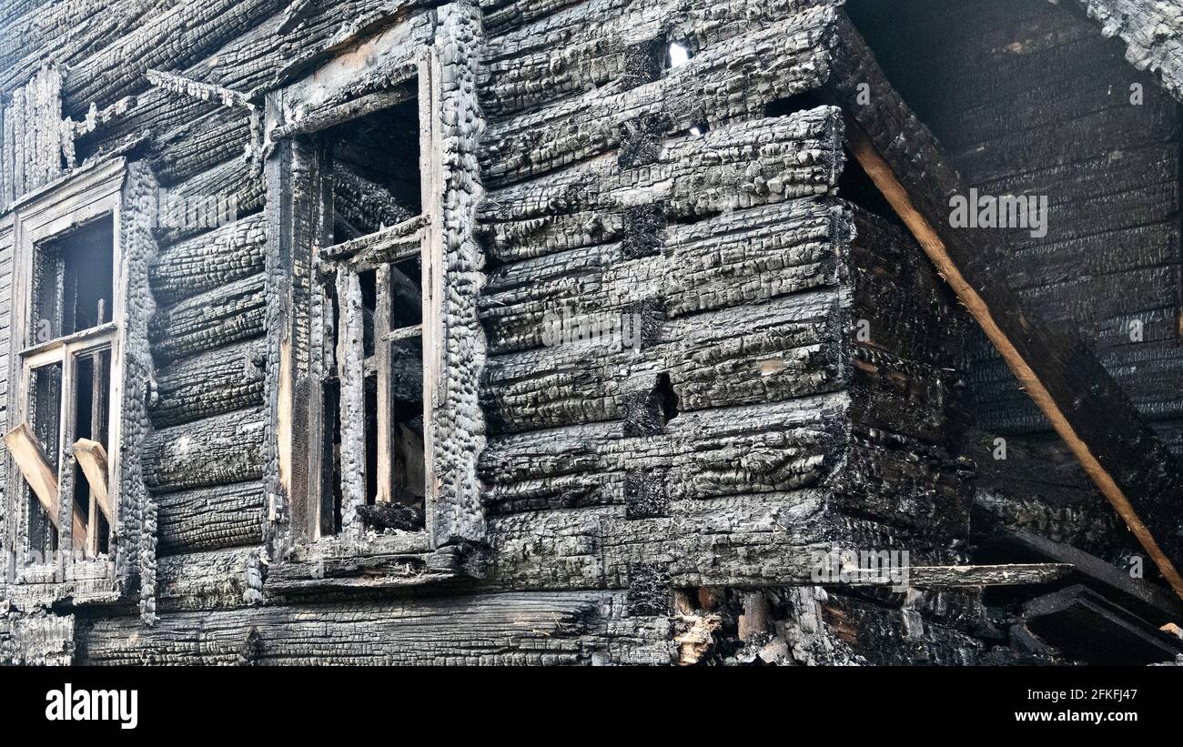 Charred ruins. Fire in the village. The outwardly burned village house ...