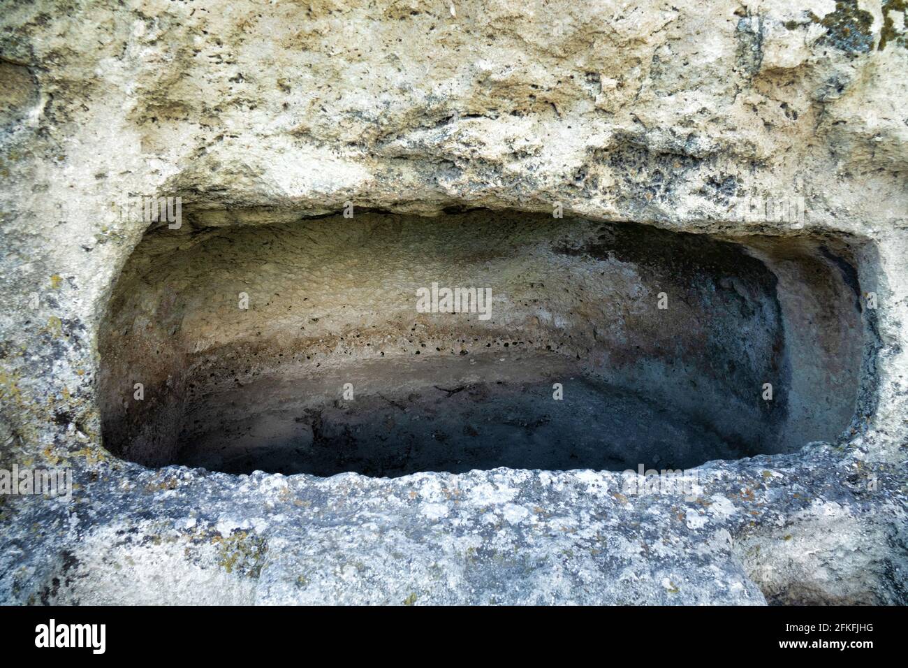Entrance to a man-made cave in a limestone rock. A place of refuge for ...