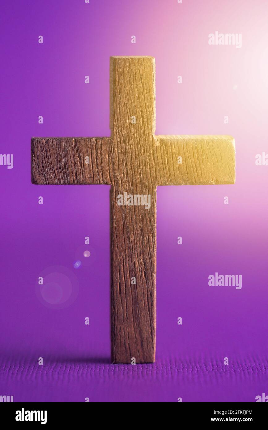 A Simple Wooden Cross on a Purple Background Stock Photo - Alamy