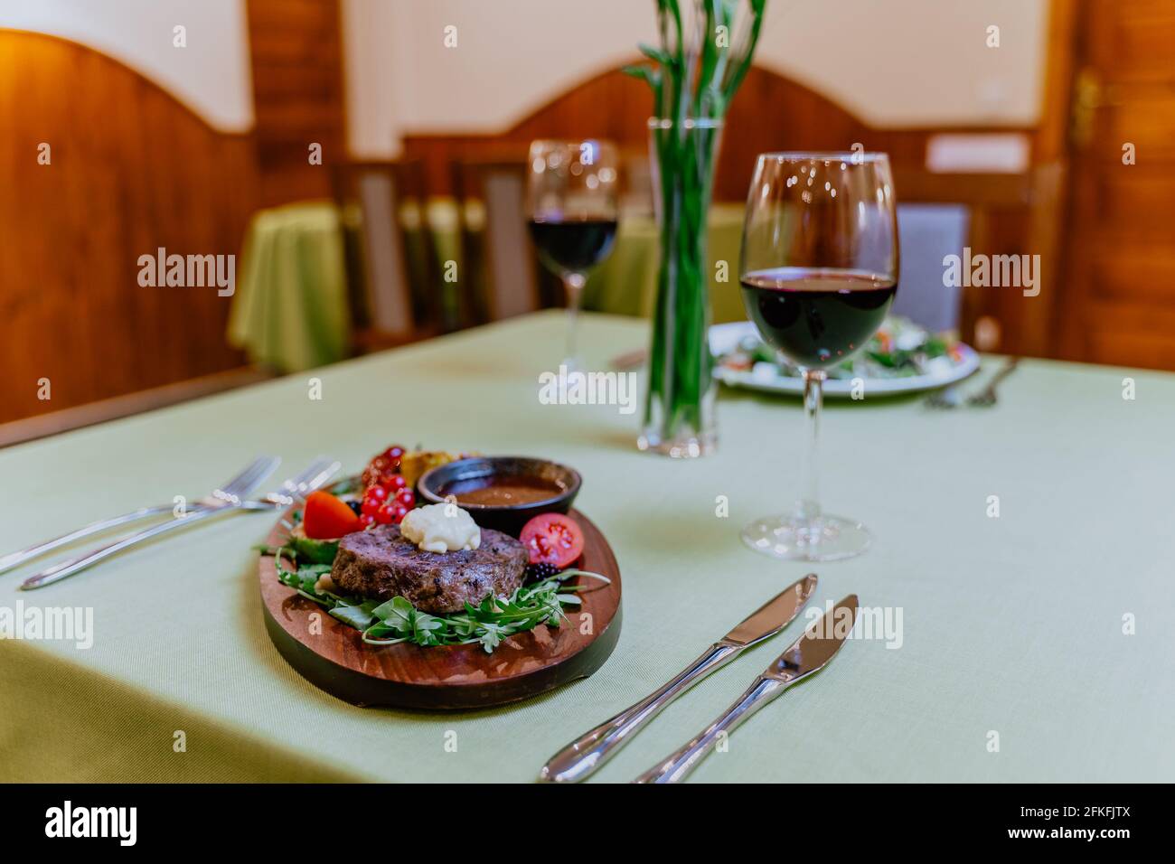 Healthy dinner table for two, with plates of tasty appetizing food and ...