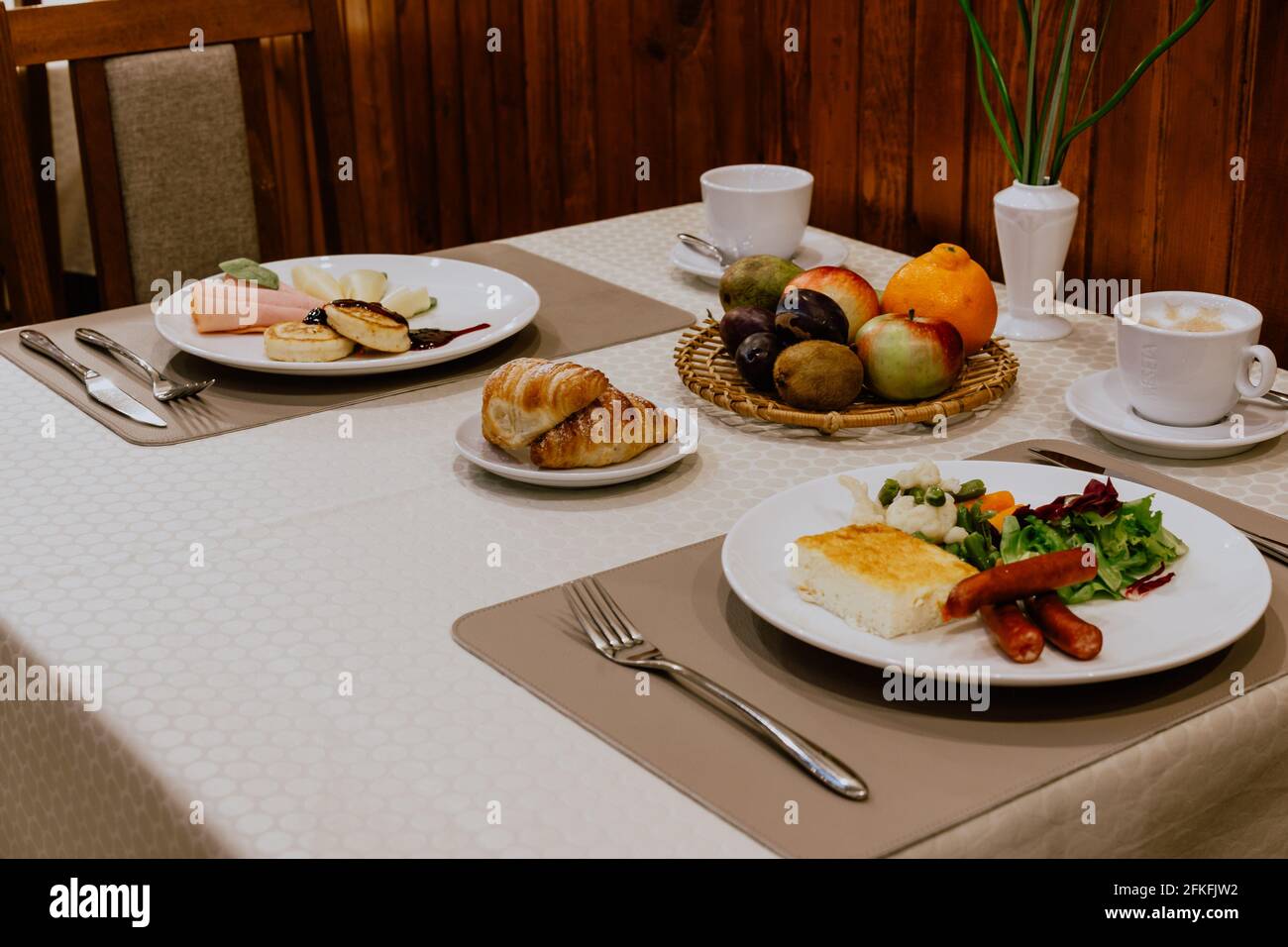 Healthy breakfast table for two, with plates of appetizing food, fruits ...