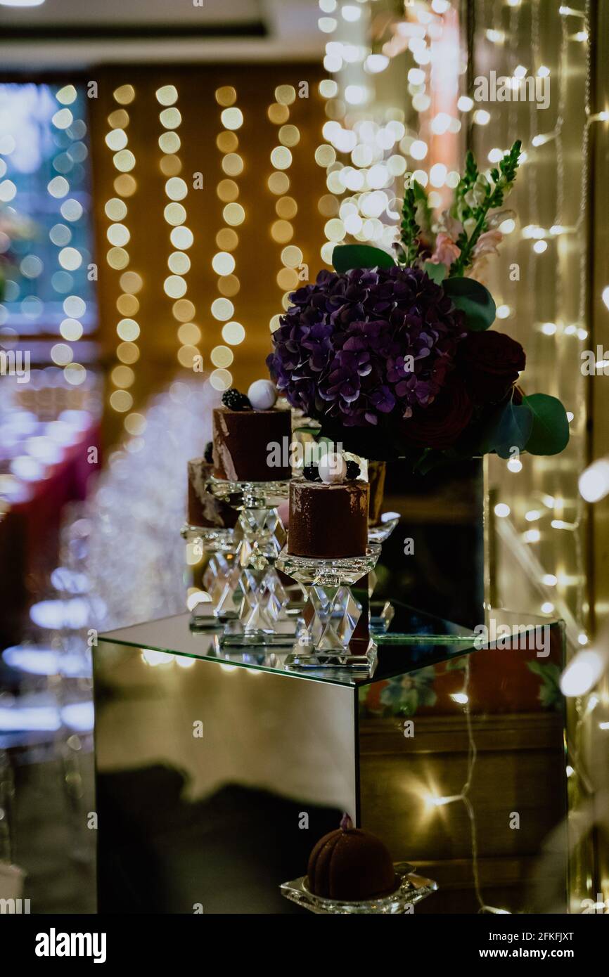 Vertical shot of a dessert corner of a restaurant with sweets and ...