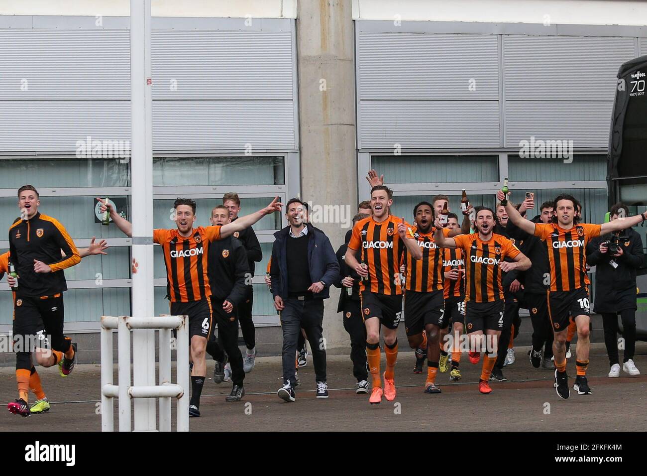 Hull City players come running out of the KCOM Stadium to the waiting fans Stock Photo - Alamy