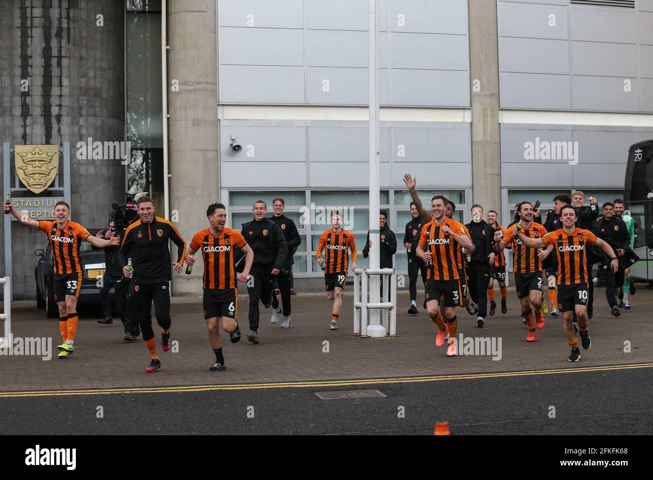 Hull City players come running out of the KCOM Stadium to the waiting fans Stock Photo - Alamy