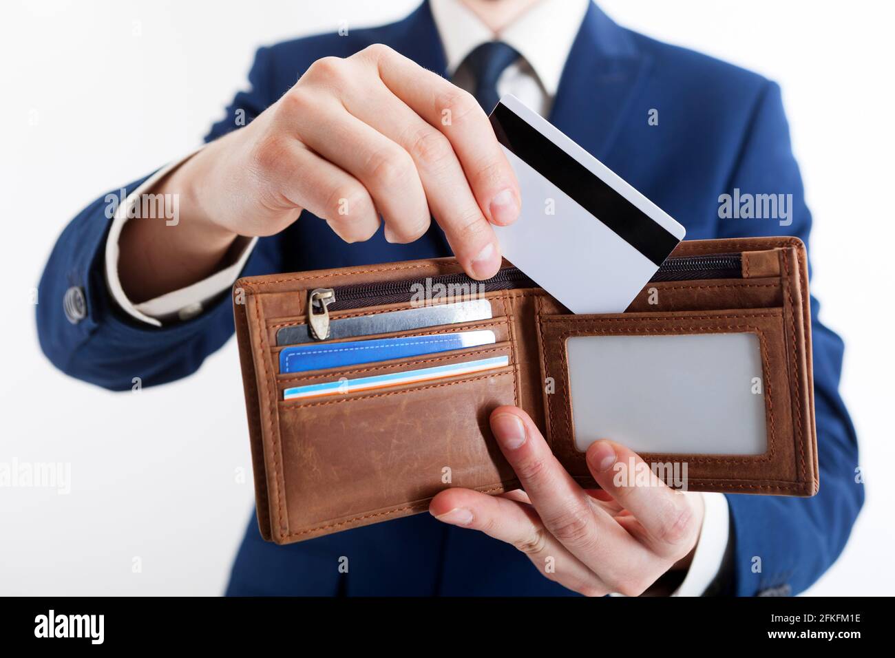 Smartly dressed business man putting a credit card into his pocket. Man ...