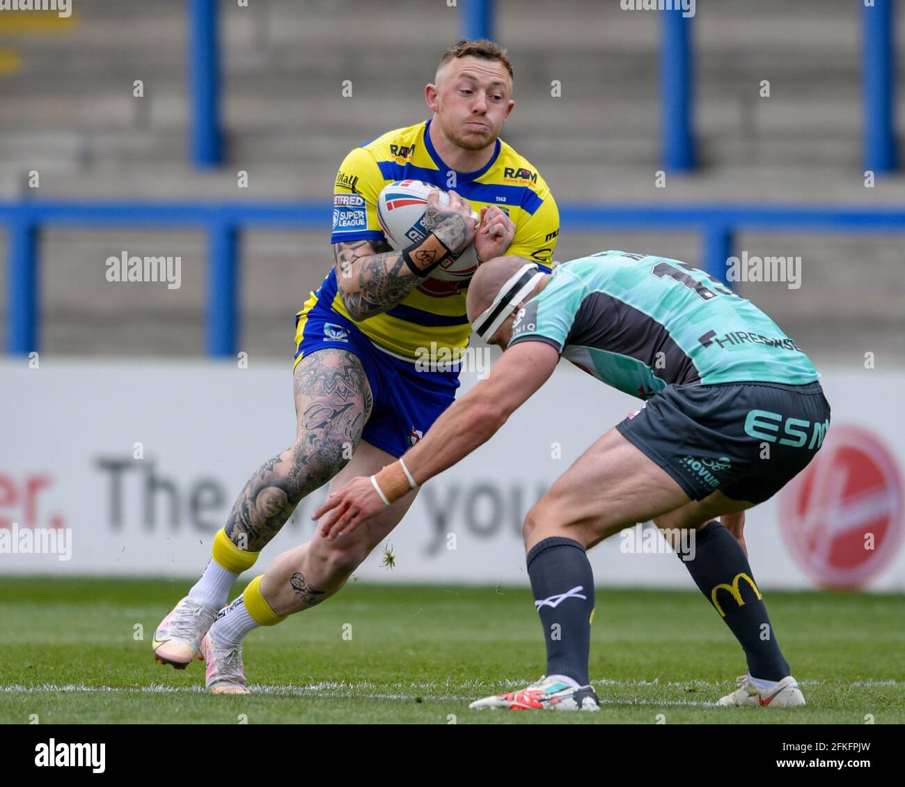 Josh Charnley (5) of Warrington Wolves is tackled by Dean Hadley (13 ...