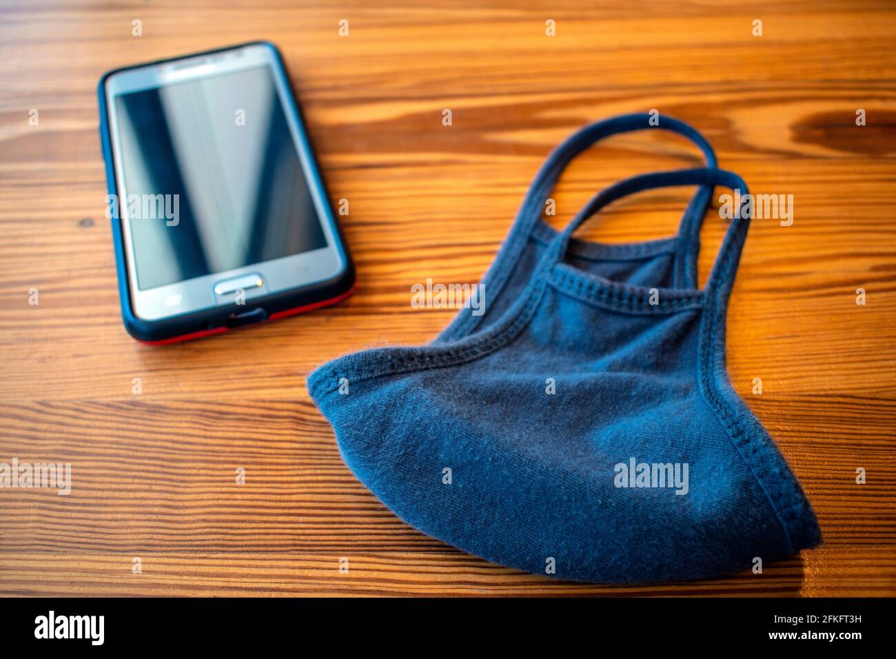 Cell phone and chinstrap or mask Stock Photo - Alamy