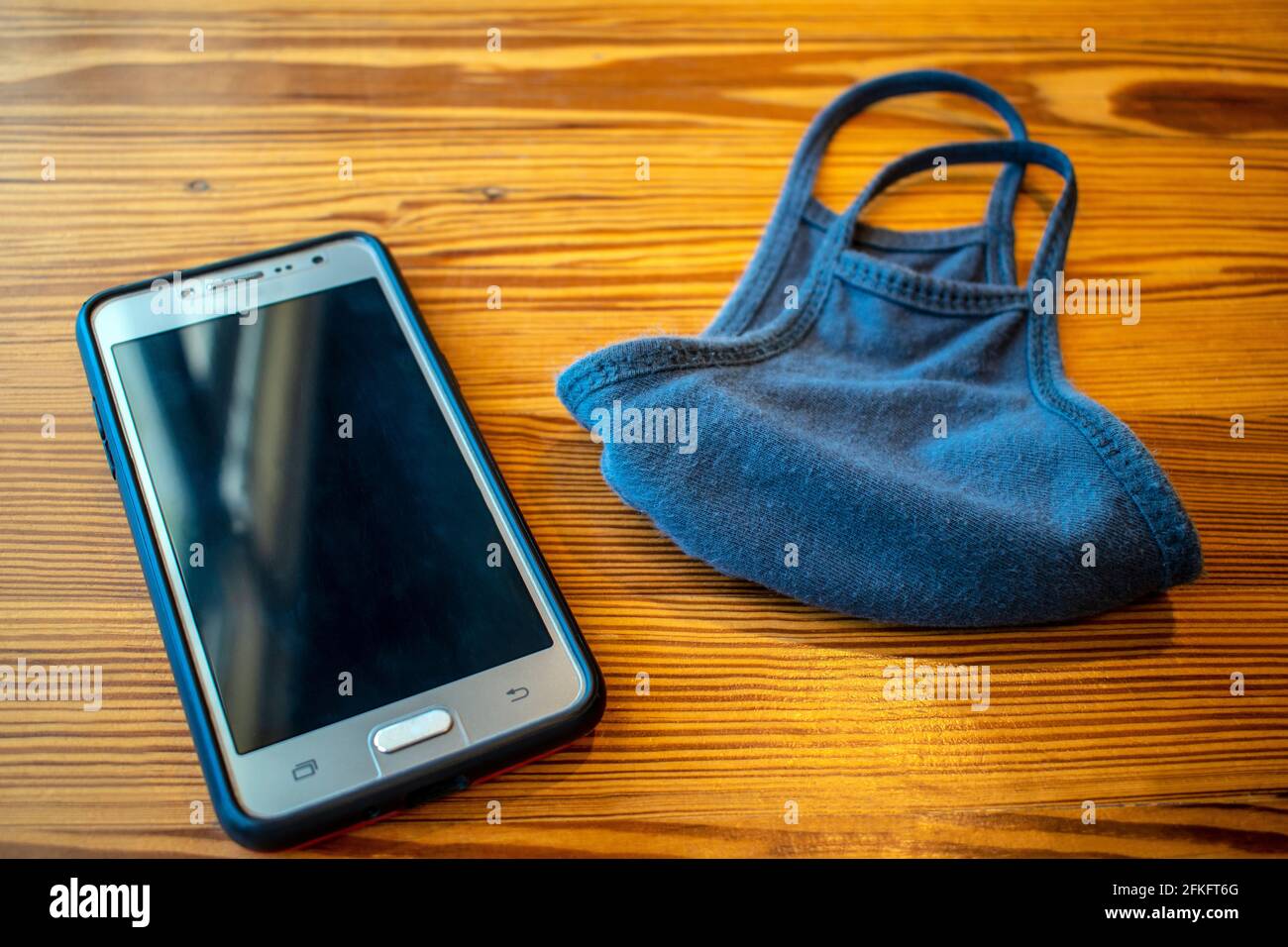 Cell phone and chinstrap or mask Stock Photo - Alamy