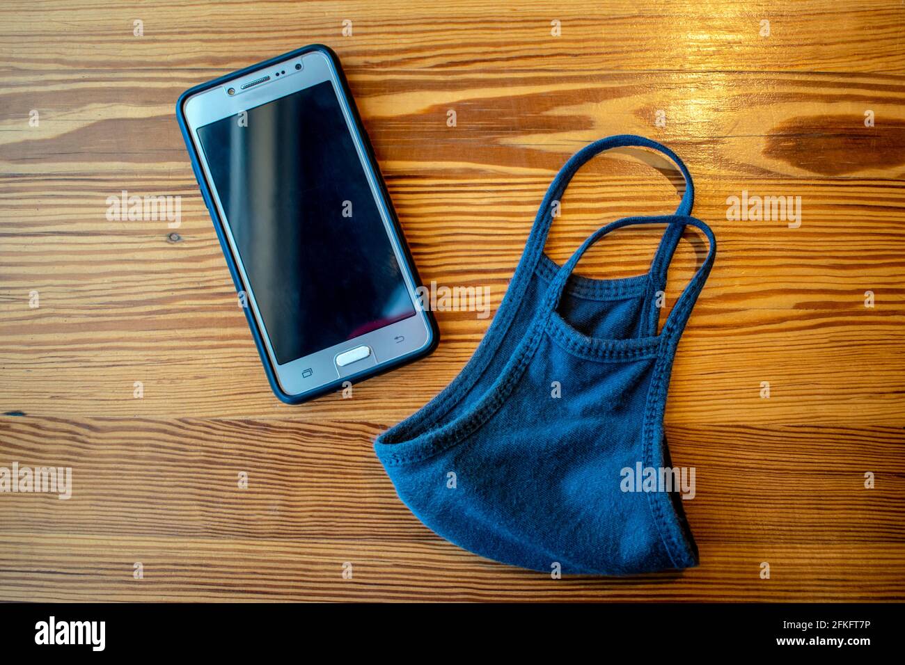 Cell phone and chinstrap or mask Stock Photo - Alamy