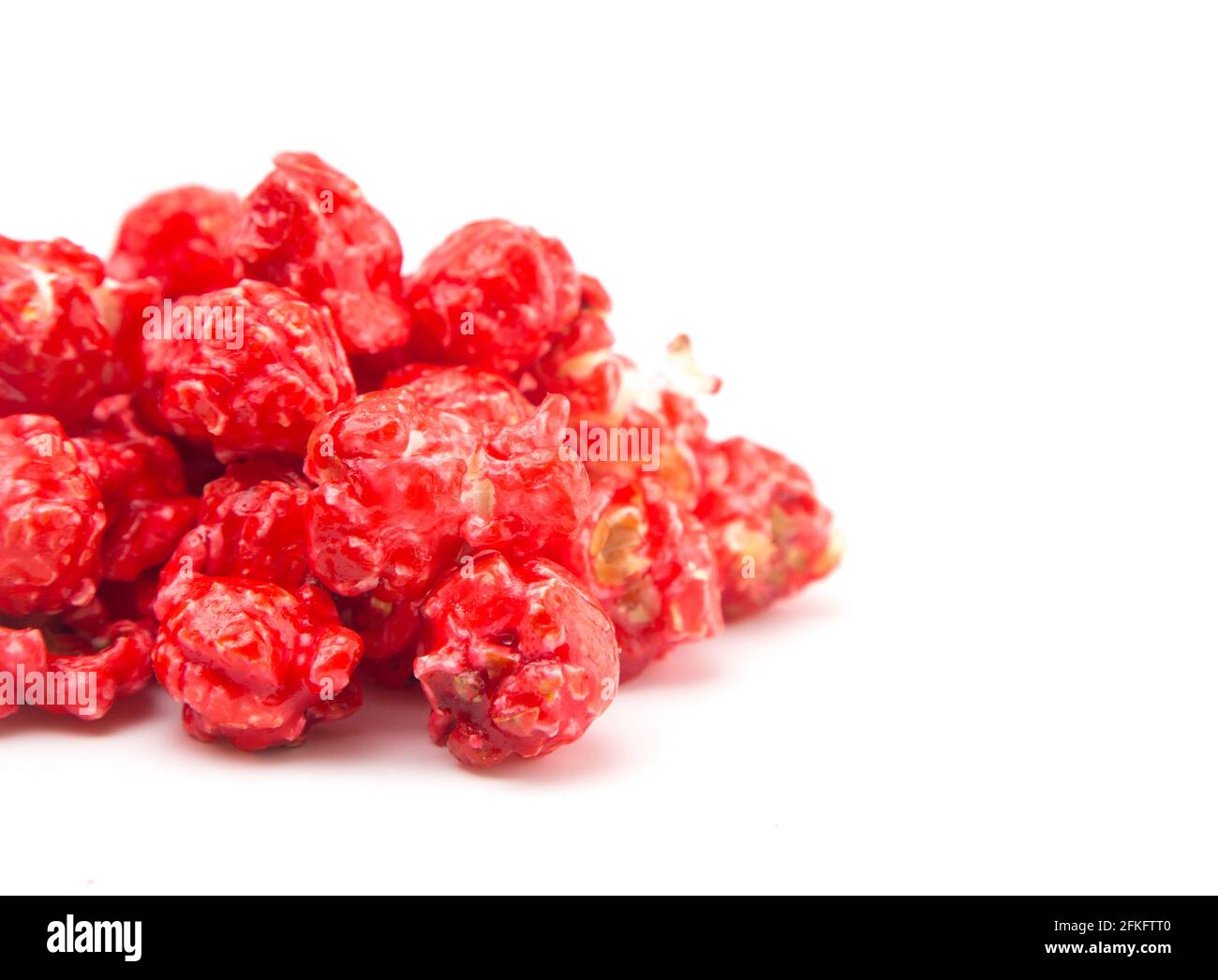 Red Colored Candy Coated Popcorn on a White Background Stock Photo - Alamy