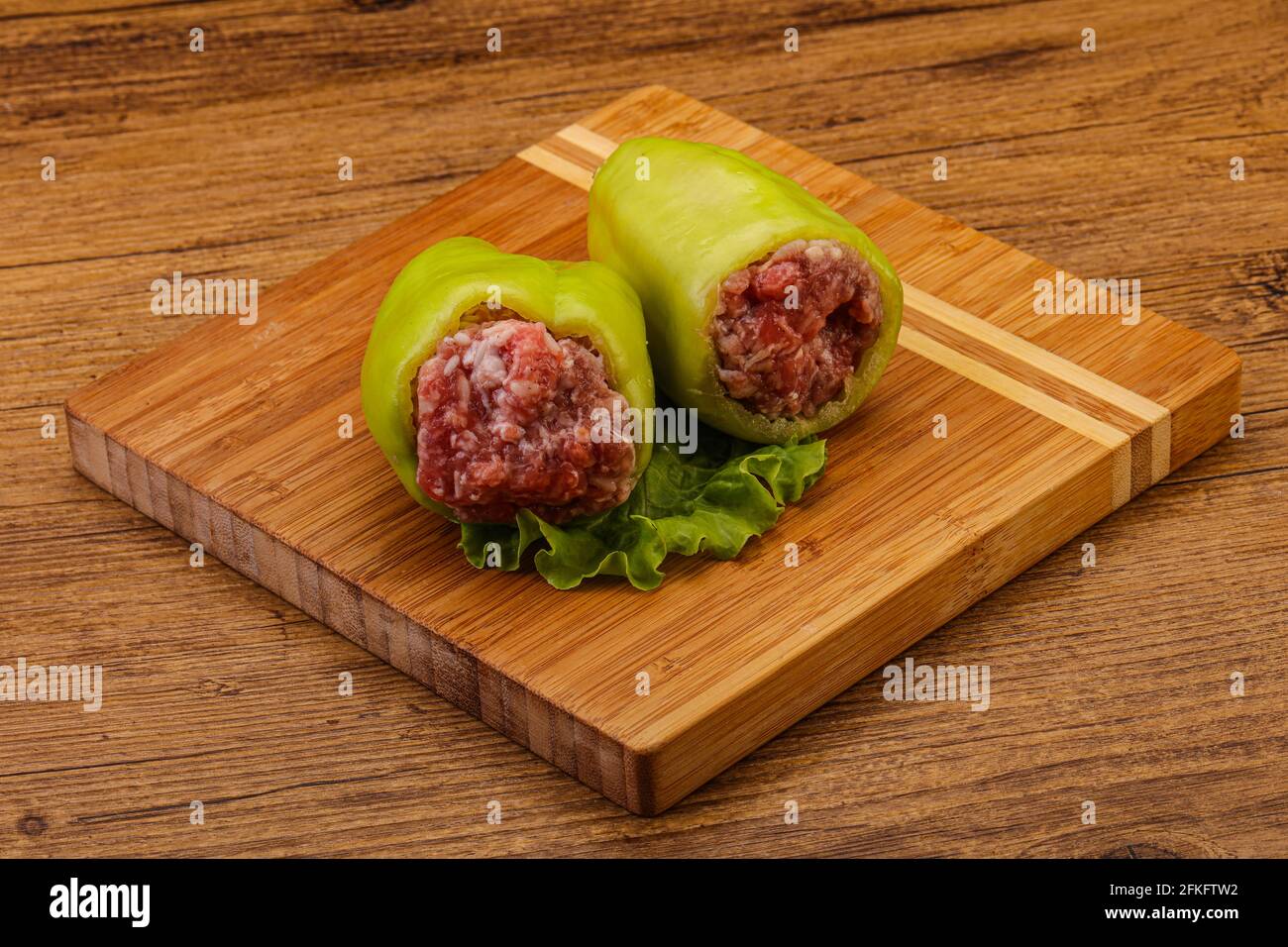 Raw stuffed green bell pepper with meat Stock Photo - Alamy