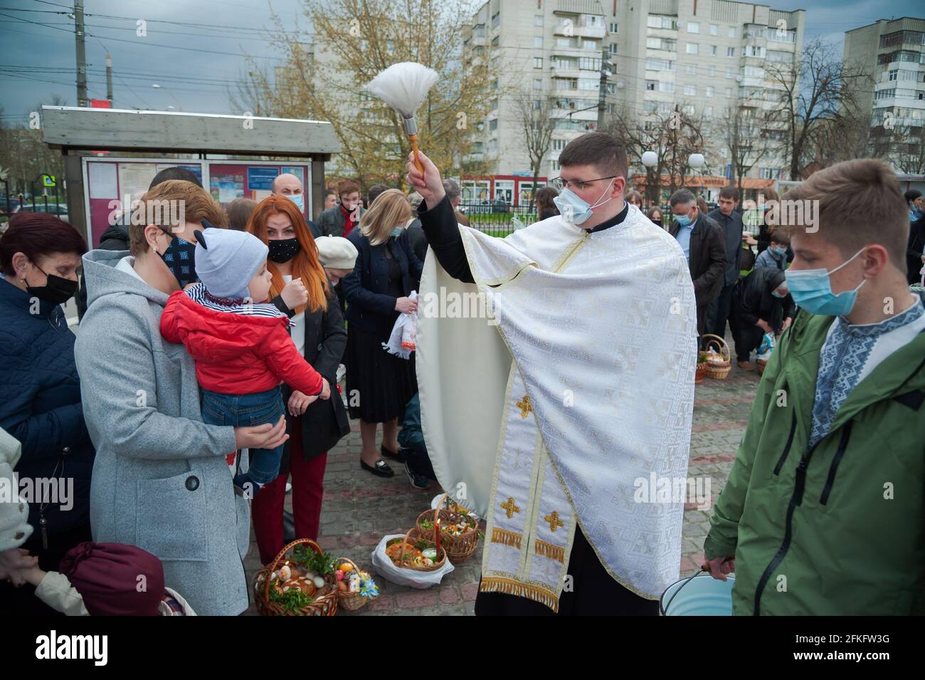 A Ukrainian priest blesses believers near the Greek Catholic Church ...