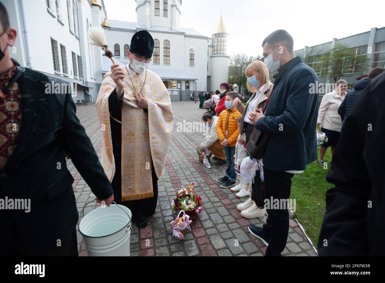 A Ukrainian priest blesses believers near the Greek Catholic Church ...