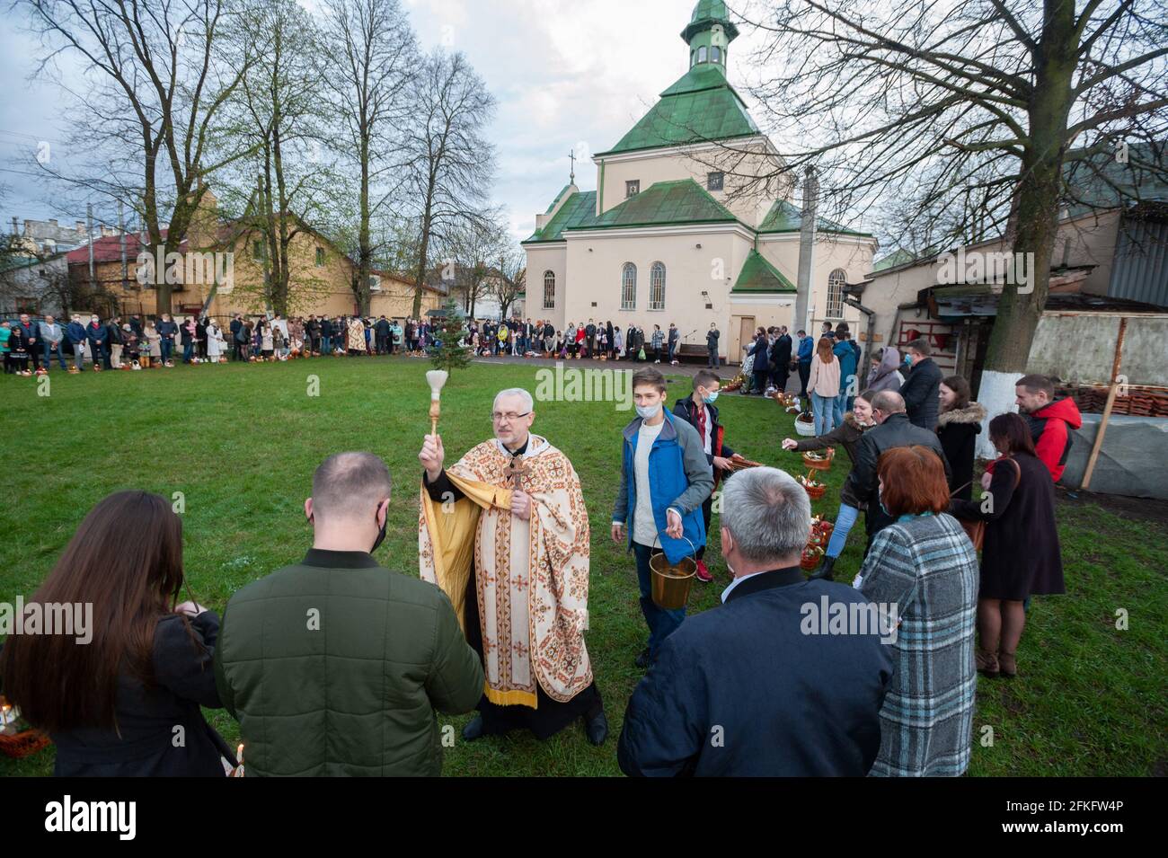 A Ukrainian priest blesses believers near the Greek Catholic Church ...