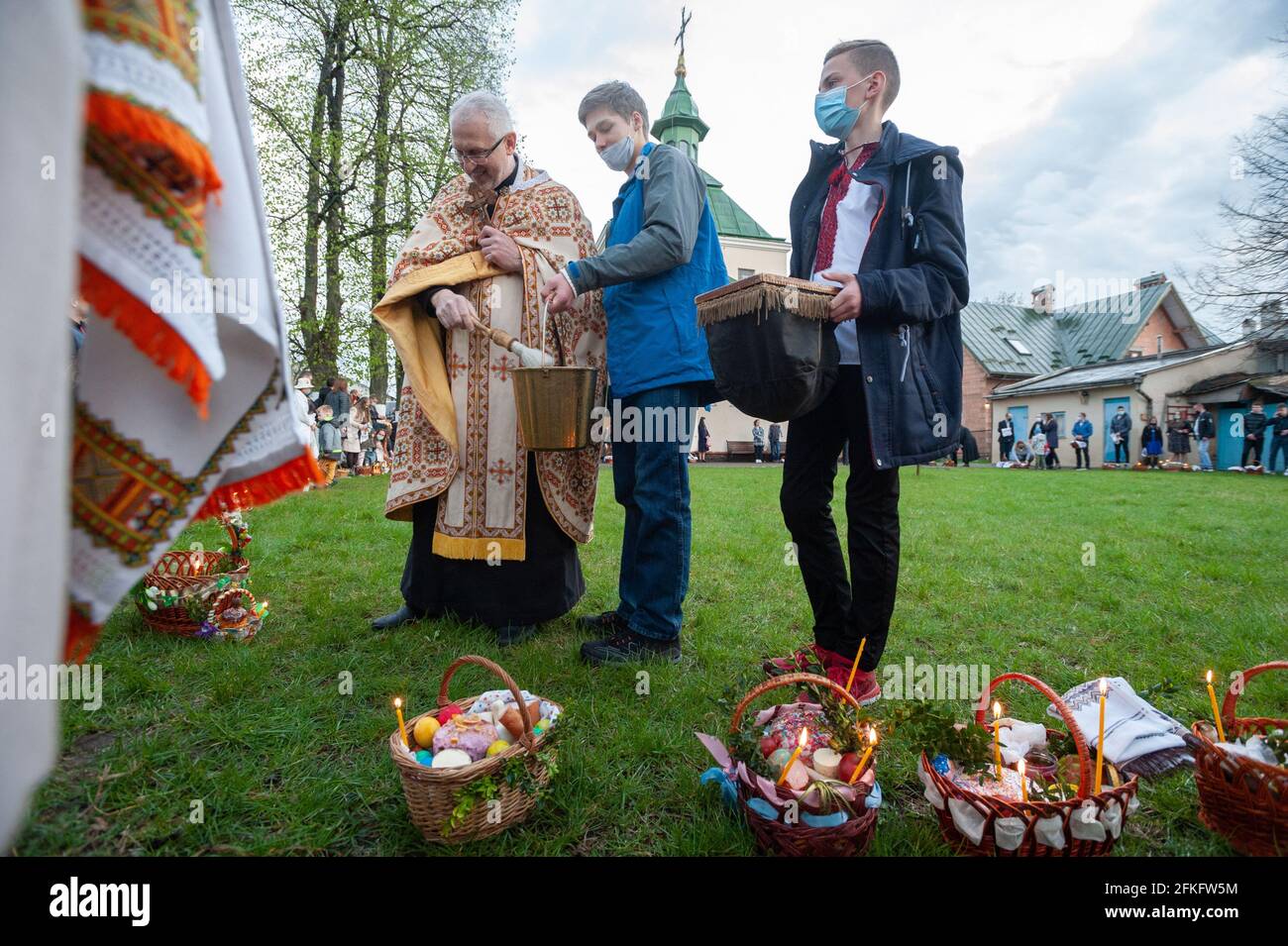 A Ukrainian priest blesses believers near the Greek Catholic Church ...