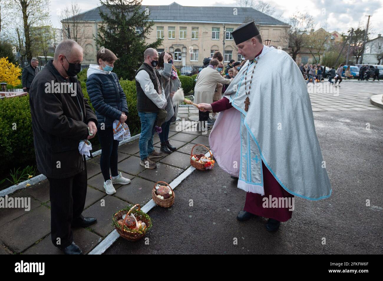 A Ukrainian priest blesses believers near Orthodox Church. Christians ...