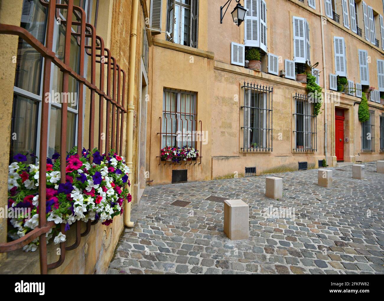 Baroque style buildings with stone walls and wooden window shutters on ...