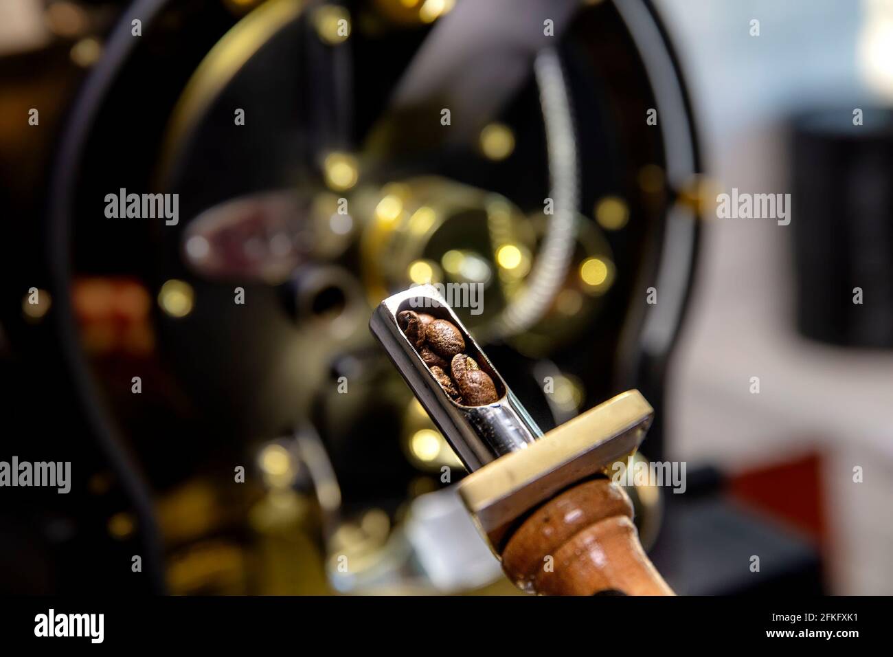 Coffee Roaster. Roasting coffee beans hand close up. Top view near ...