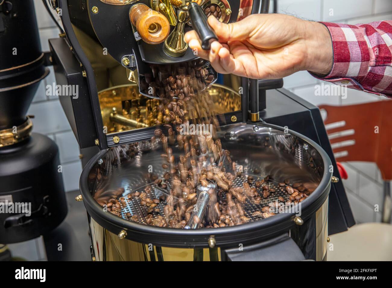 Coffee Roaster. Roasting coffee beans hand close up. Top view near ...
